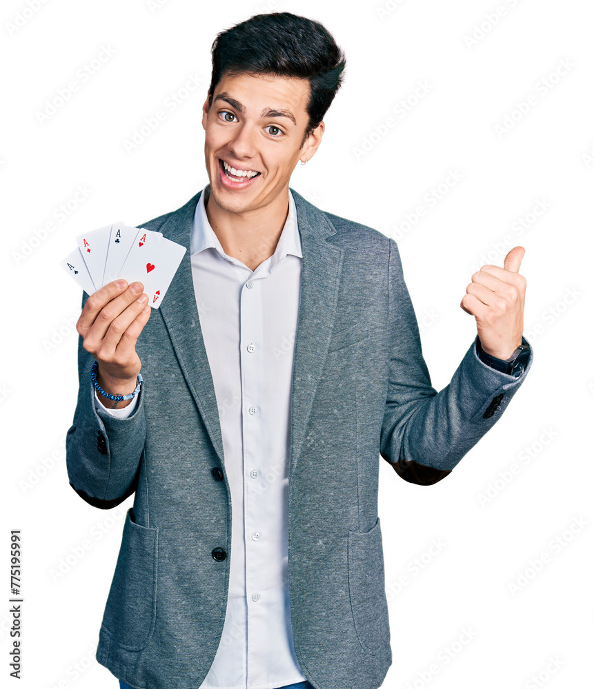 Young hispanic business man playing poker holding cards pointing thumb ...