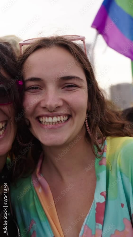 Vertical of Two young loving girls kissing on gay pride festival day ...