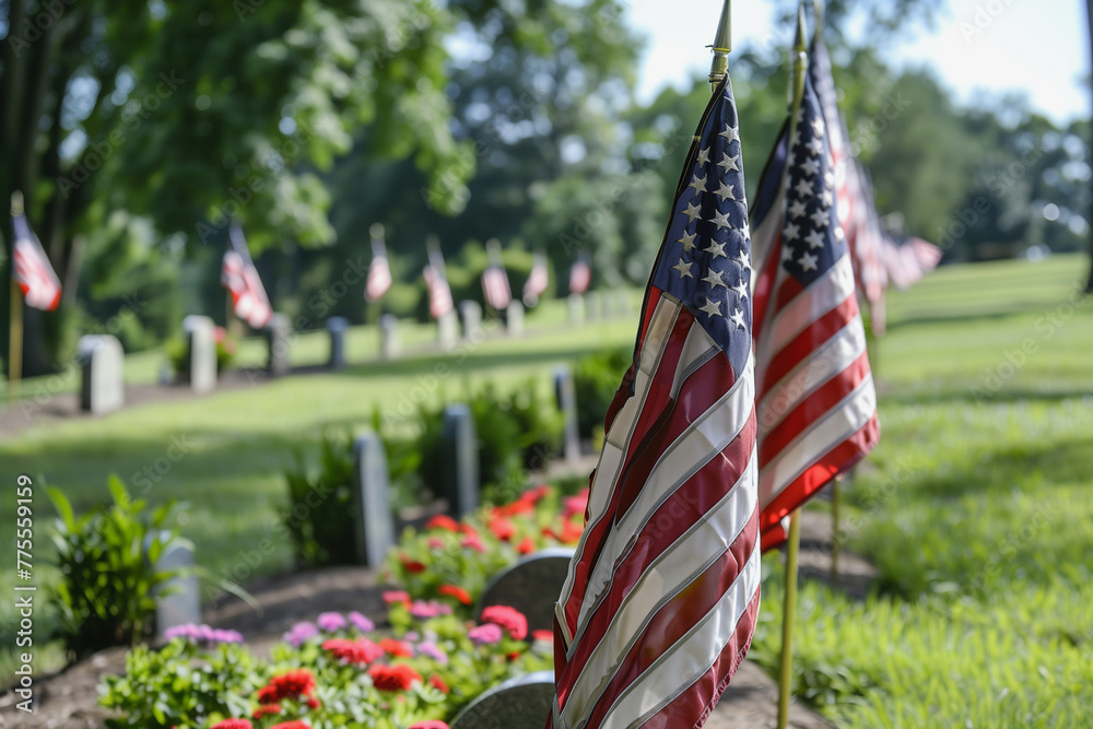 A cemetery with four American flags in the grass. The flags are in ...