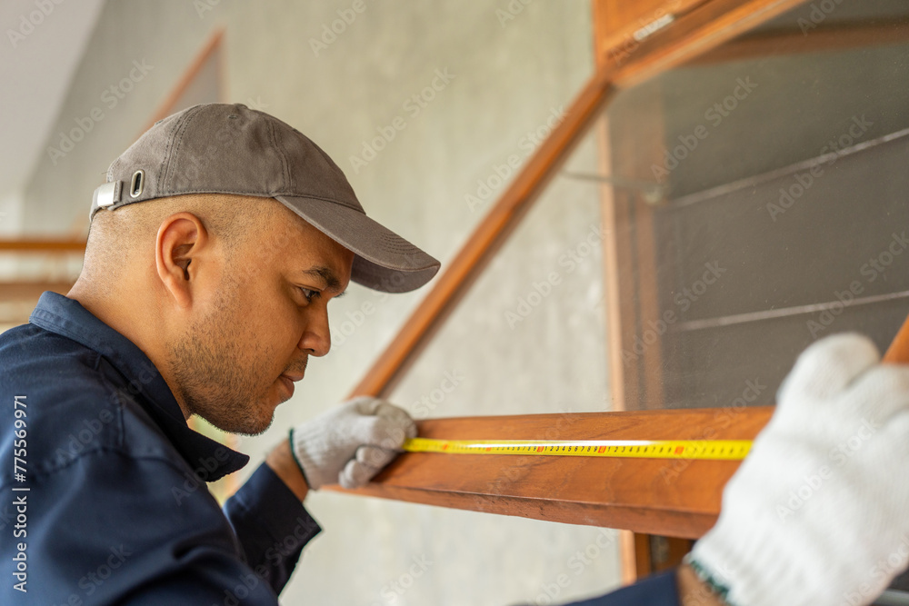 Technician worker in uniform using measuring tape tool to measuring ...