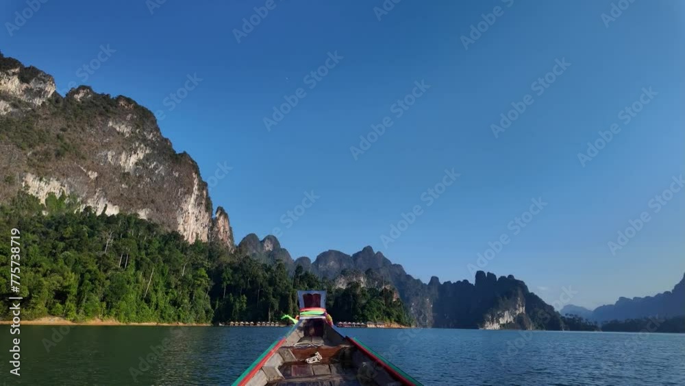 Riding on a tourist boat in sunny weather. Khao Sok is a park known for ...