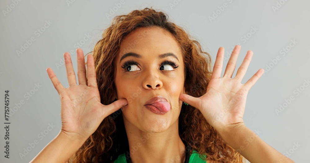 Woman, funny face and studio with goofy comedy on grey background or ...