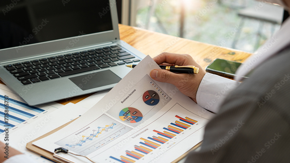 Business accounting concept Businessman uses calculator with laptop ...