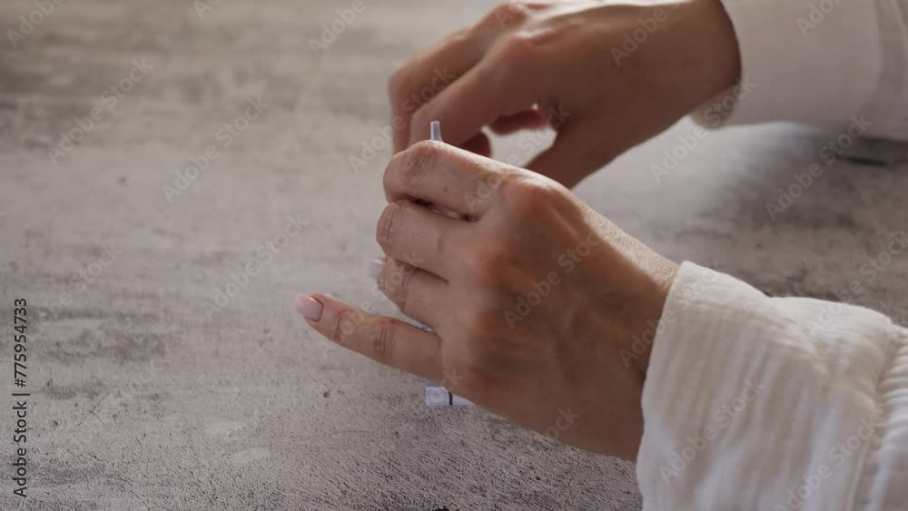Woman squeezes cream drop onto finger from tube Applying to skin she ...