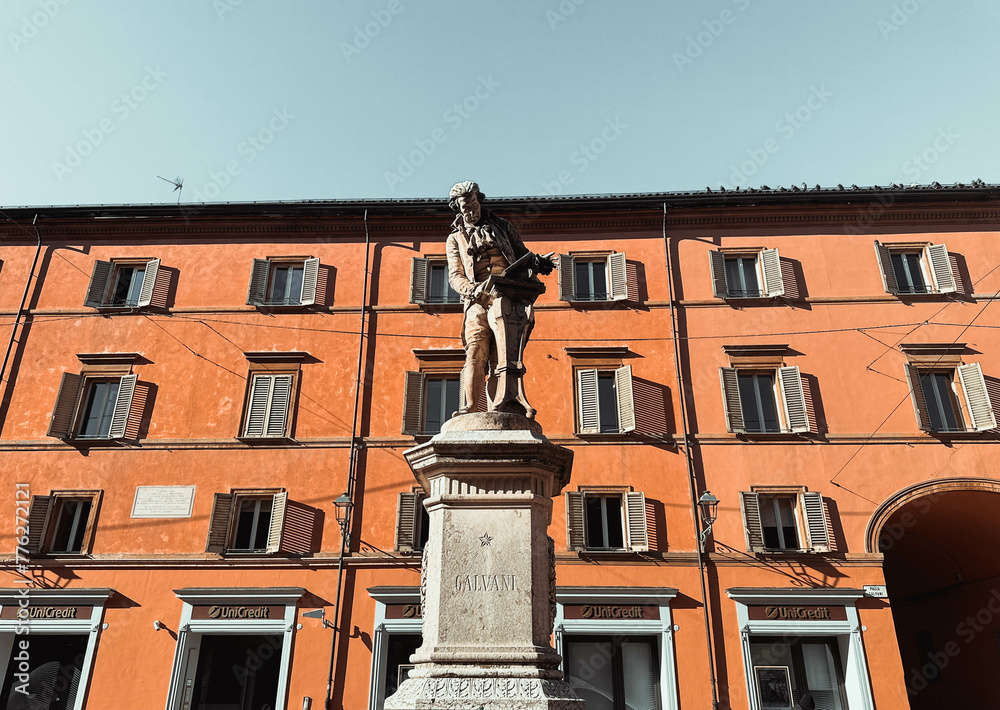 View of monument and old orange building facade in Bologna, Italy. Old ...