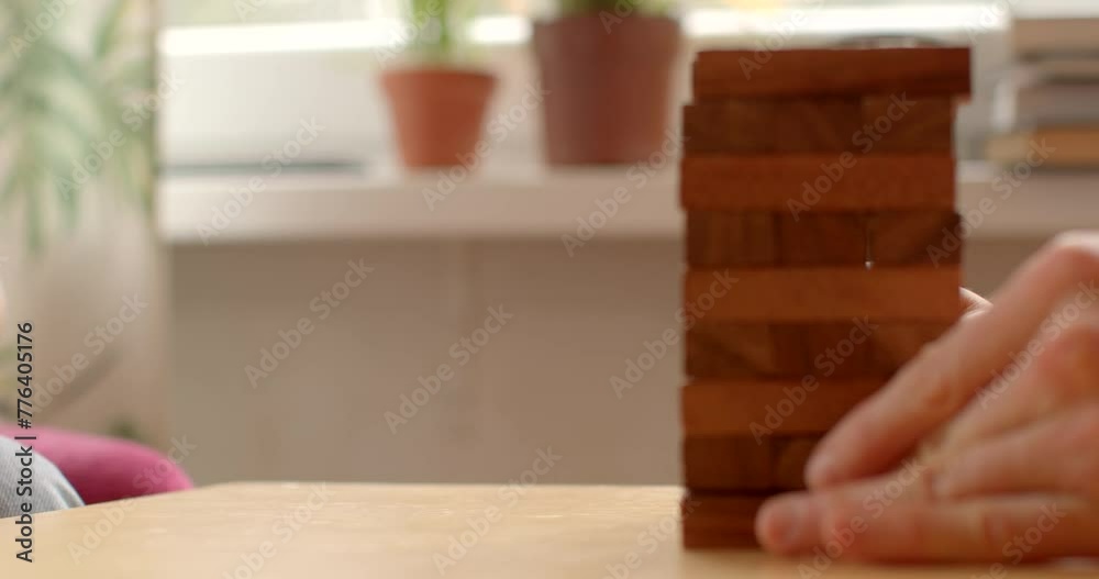 Two pairs of hands are building a tower with blocks. Illustrating the ...