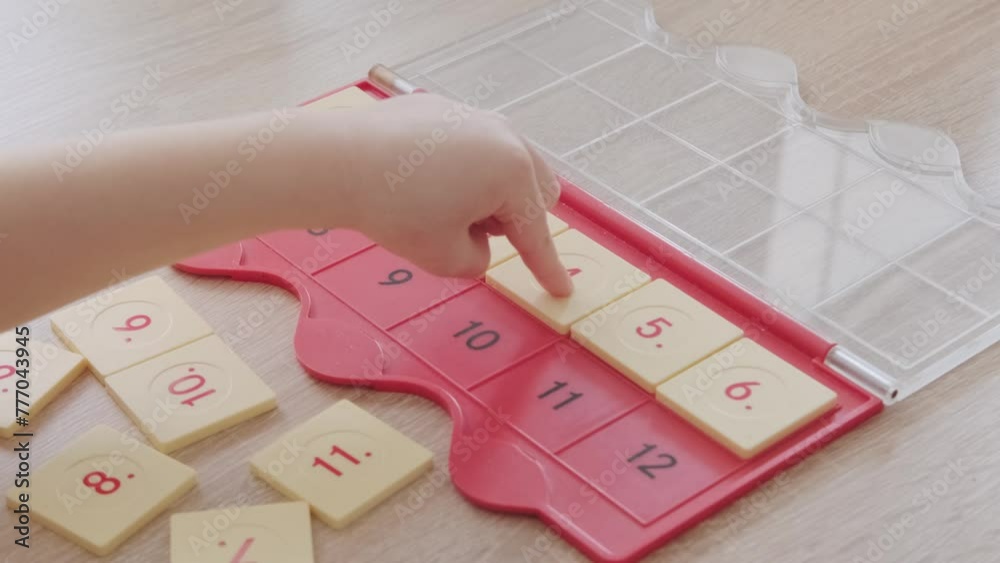 little child's hands arranging numbers in order, preschooler learning ...