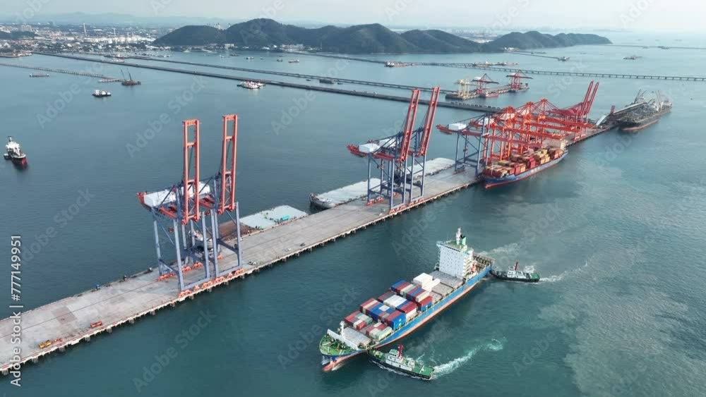 Tug boat pulling Cargo Container Ship into Cargo international sea port ...