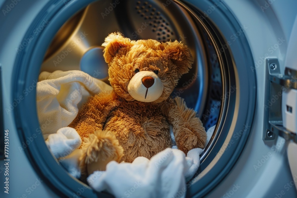 Teddy bear toy sitting in washing machine, children's toy cleaning ...