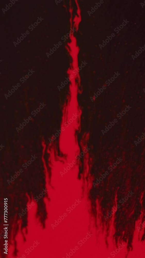 Vertical video. Paint drip. Ink splash flow. Flame wave. Red color ...