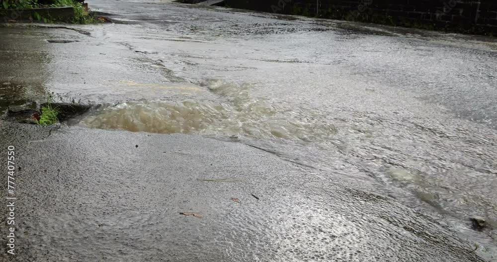 Vidéo Stock Water from clogged side ditch flows directly onto village ...