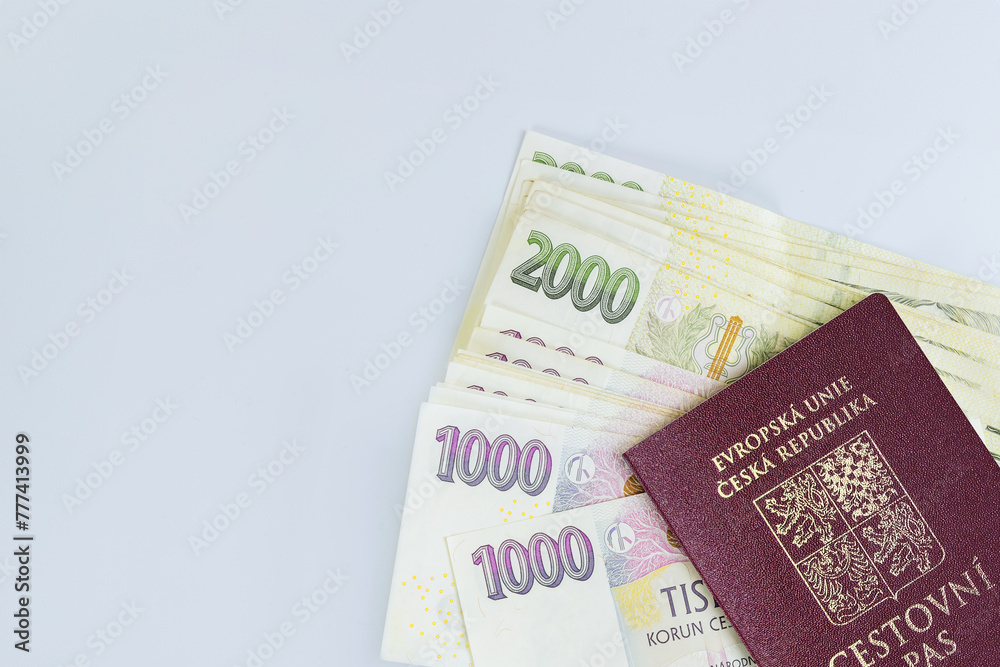 Various denominations of CZK koruna banknotes are stacked on white ...