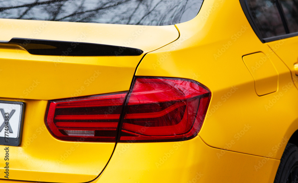 Kyiv. Ukraine. April 2024. Yellow BMW car close-up. LED tail light bulb ...