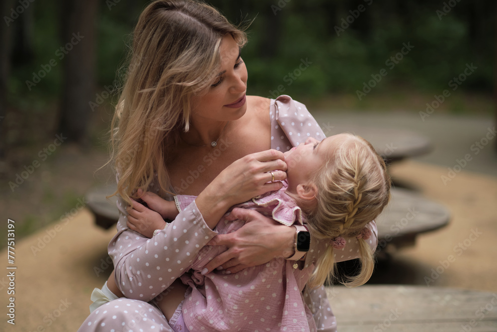 Embracing Motherhood: The tender touch of a young child nestled against ...