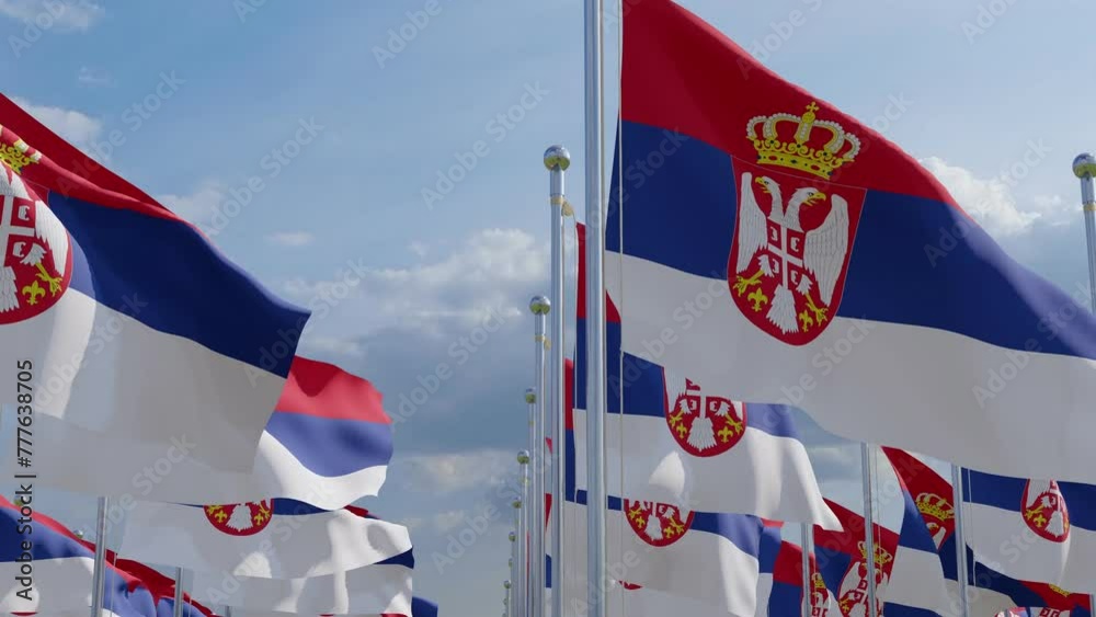 National flags of Serbia waving in the wind on a clear day. Democracy ...
