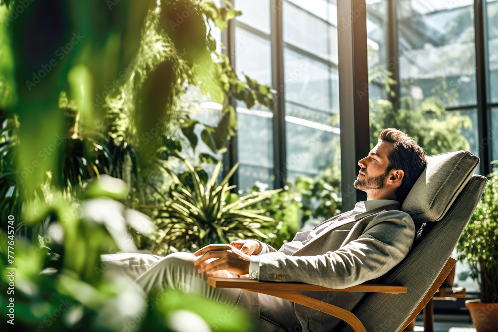 Man employee in suit relaxing in recliner lounge chair in break area ...
