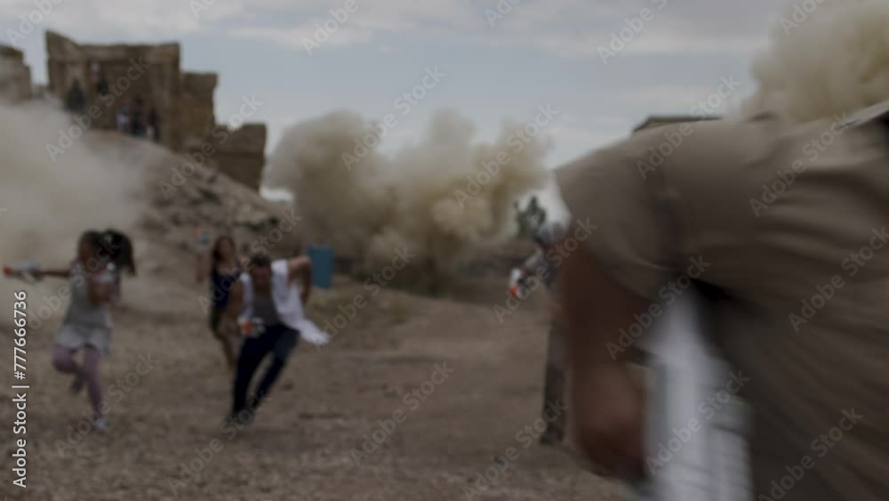 People running away from epic explosions in desert and man yelling ...