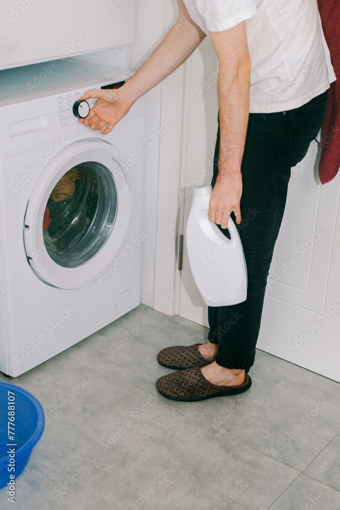 An unrecognisable man chooses a washing machine programme Stock Photo ...