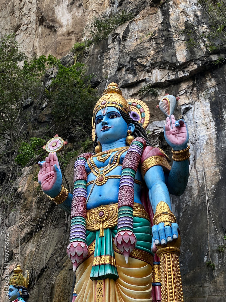 Blue sculpture of Hindu god in rock temple at Batu Caves Stock Photo ...