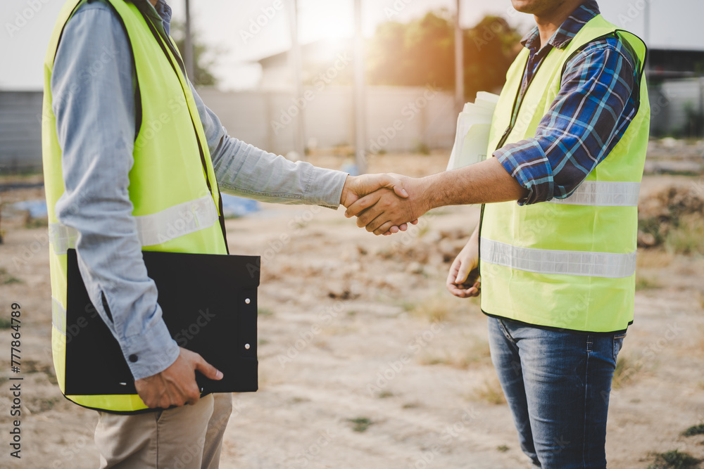 construction worker and contractor. Client shaking hands with team ...