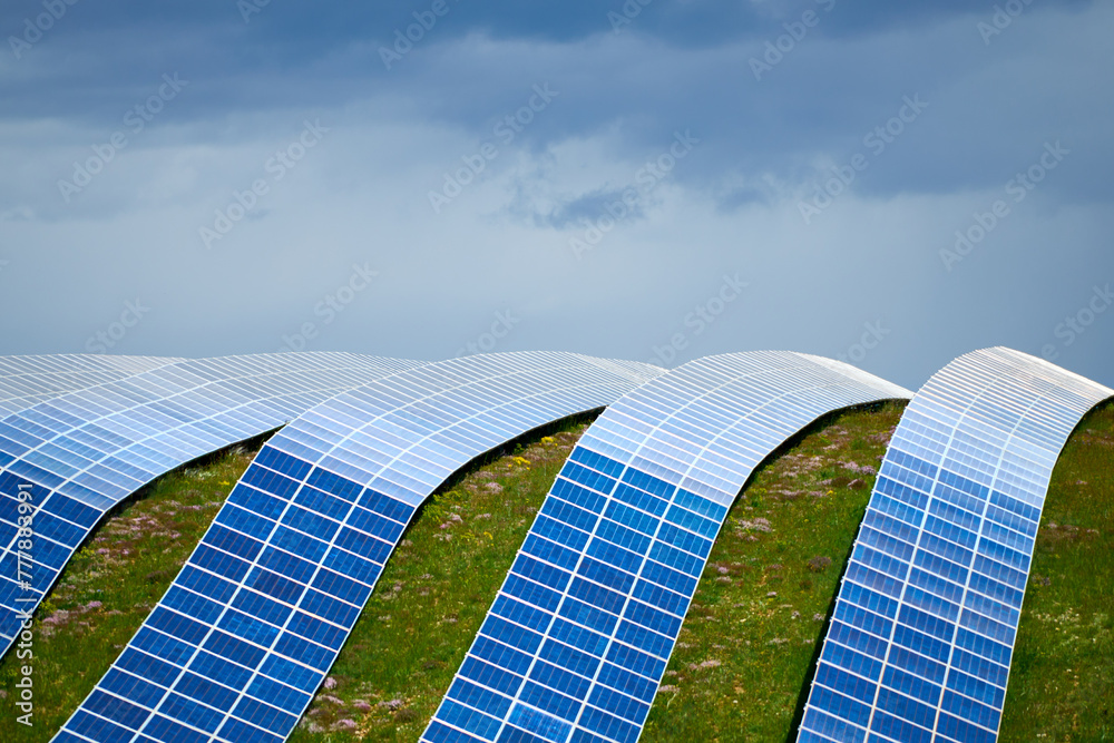 Ribbons of PV solar cells, curving shapes over mountain terrain Stock ...