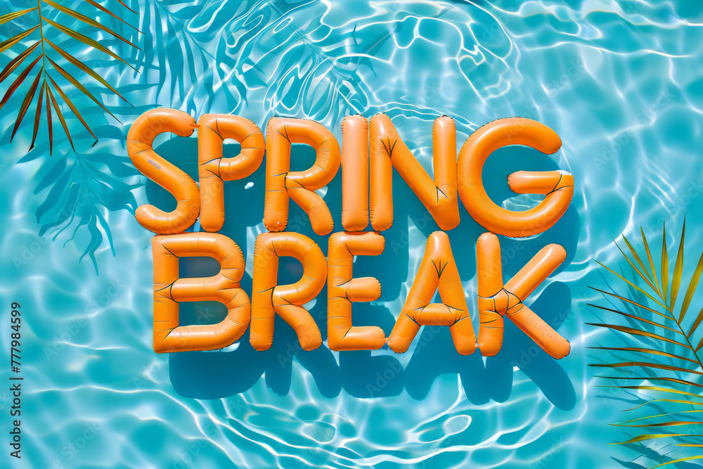 Spring break word spelled out in inflatable pool floats in a summer ...