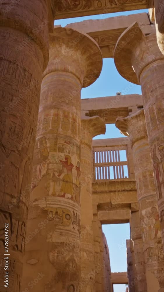 Camera moves between columns with ancient Egyptian drawings. Karnak ...
