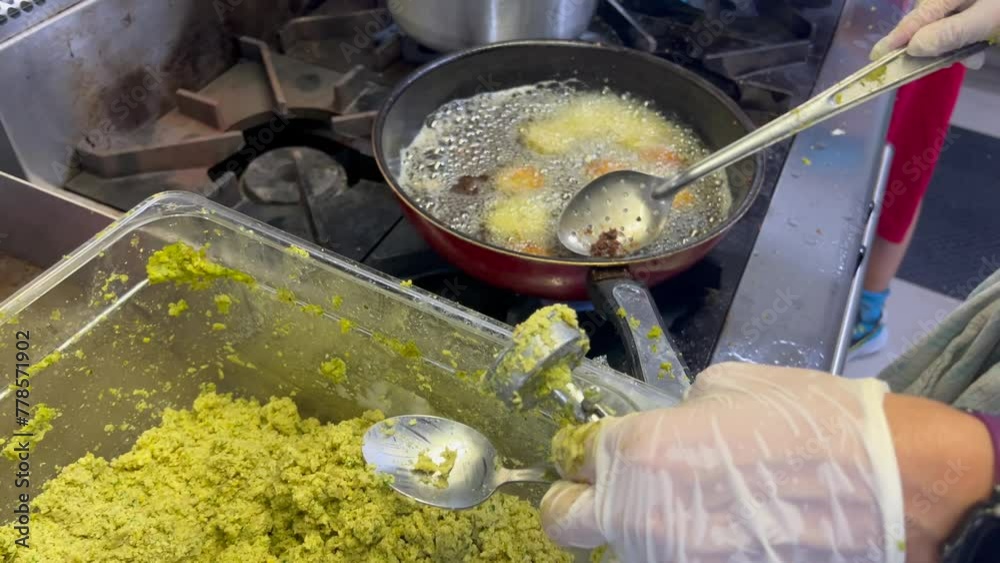 Middle Eastern chef preparing Falafel balls, a deep-fried ball or patty ...