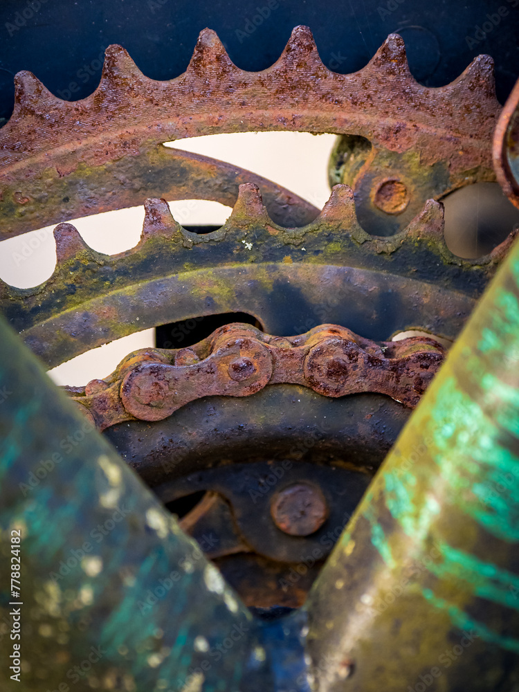 A detailed close-up reveals rusted front chainrings and a corroded ...