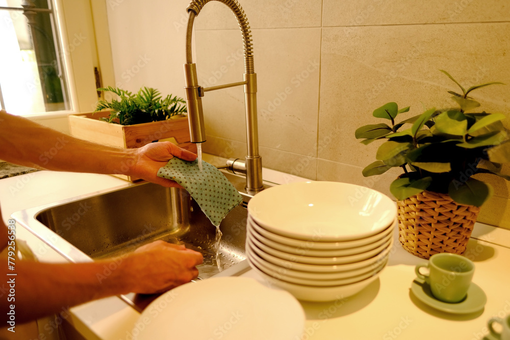 young man 30-35 years old washing dishes, Sharing household tasks ...