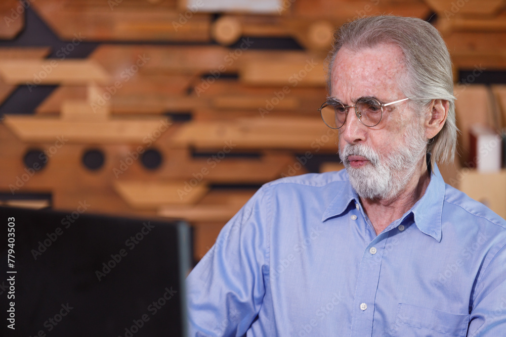 senior handsome man wear glasses using computer with grey hair and ...