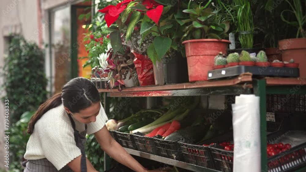 Female vegetable vendor put leek on shelve. Fruits seller lady. Woman ...