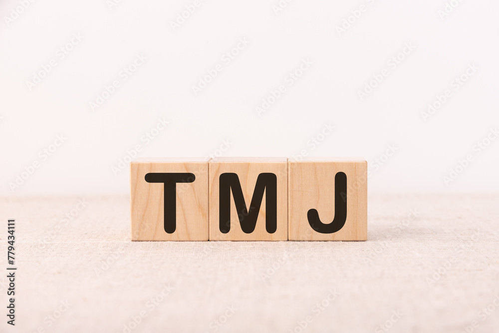 TMJ - acronym from wooden blocks with letters, abbreviation TMJ ...