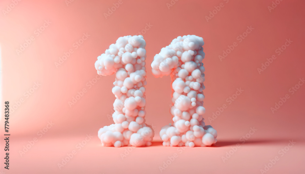 Cotton balls create the number eleven on a peach background, suited for ...