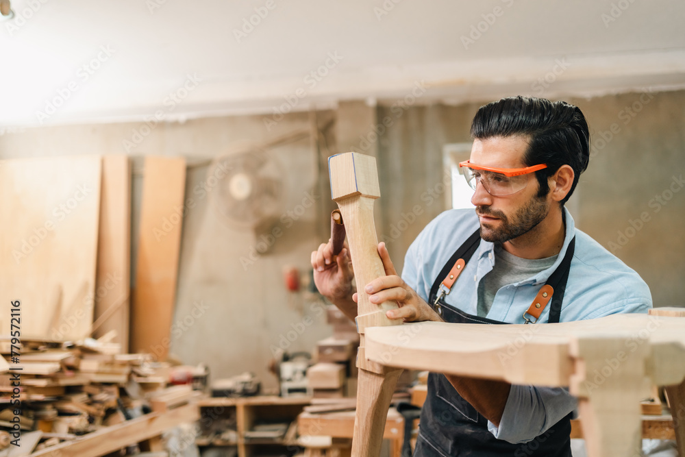 Diligently skilled man work with wood in carpenter's shop, using tools ...