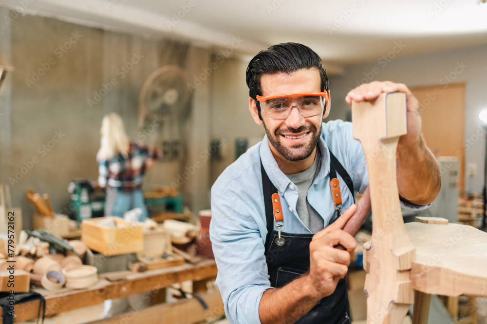 Diligently skilled man work with wood in carpenter's shop, using tools ...