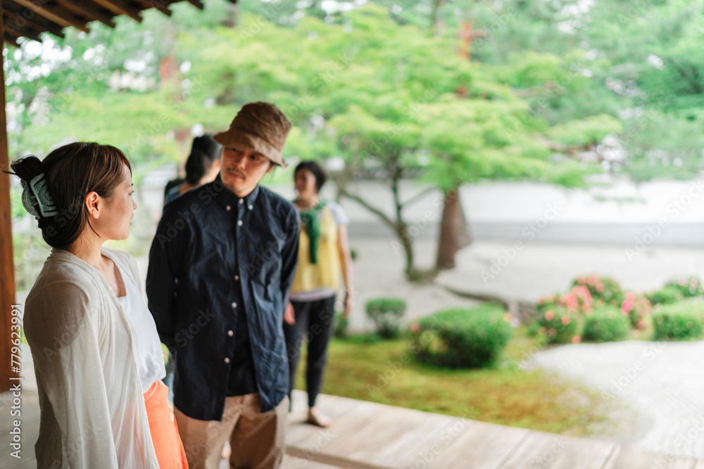 Japanese friends engage in conversation while walking through the ...