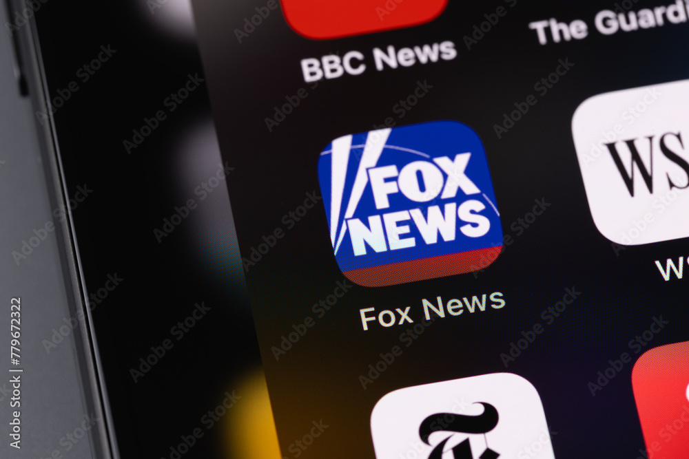 Fox News logo mobile app icon on a screen smartphone, iPhone closeup ...
