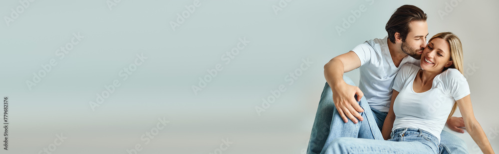 couple sharing an intimate moment, man kissing cheek of woman in a ...