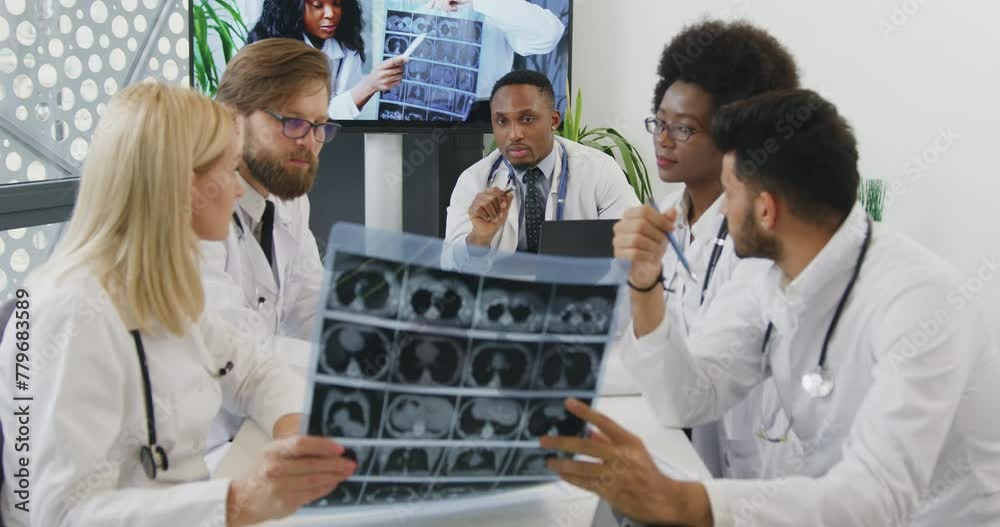 Multiracial doctors team advising about the treatment of patient using ...
