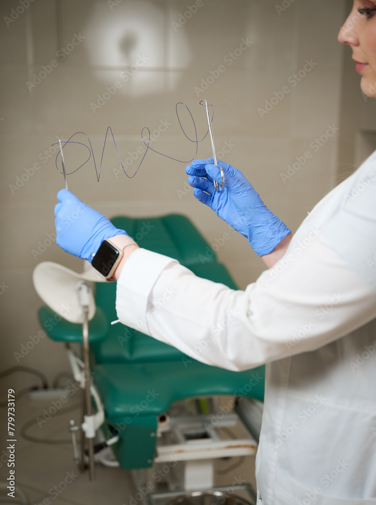 Pretty female doctor gynecologist in blue medical sterile gloves ...