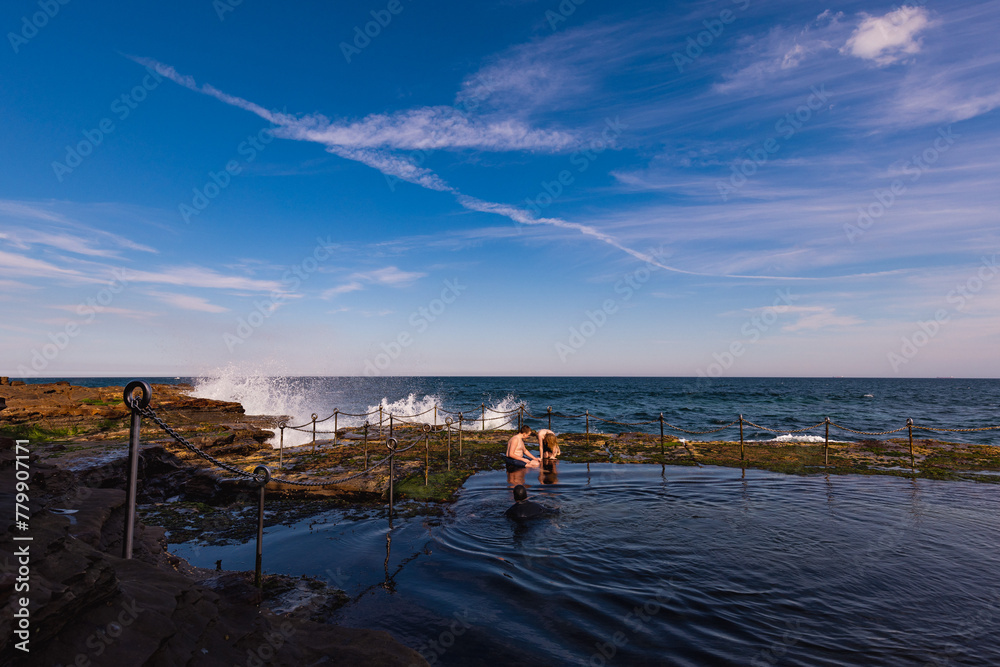 Children swimming in the Bogey Hole, historic man-made rock pool in ...