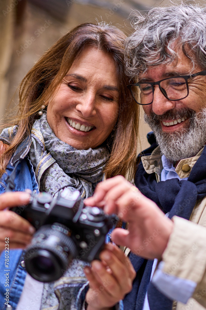 Vertical. Close up smiling retired couple holding and looking at camera ...