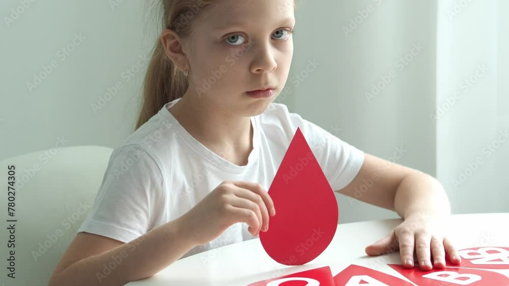 Sad girl in hand holding a drop of blood cut from paper, blood ...