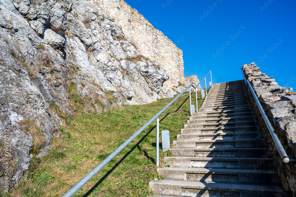 Stairs under the historic stone walls of Devín Castle on a rocky cliff ...