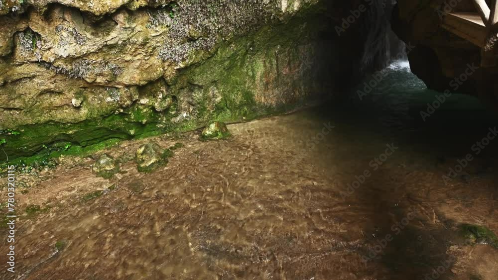 A stream of pure and clean flowing river water, forming waterfall in ...
