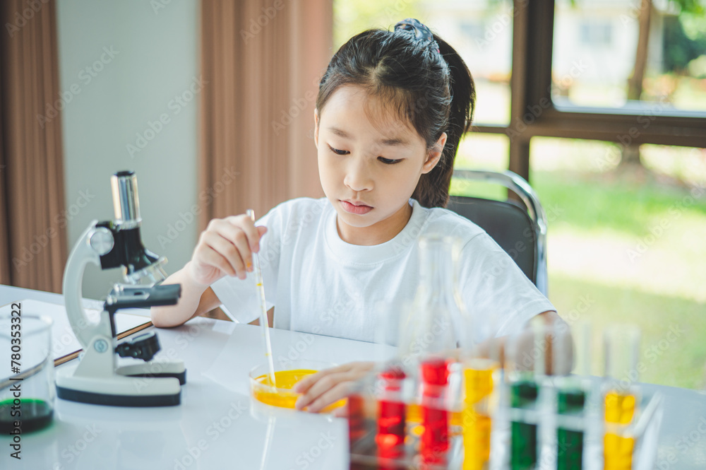 little scientist looking through a microscope and test tubes filled ...