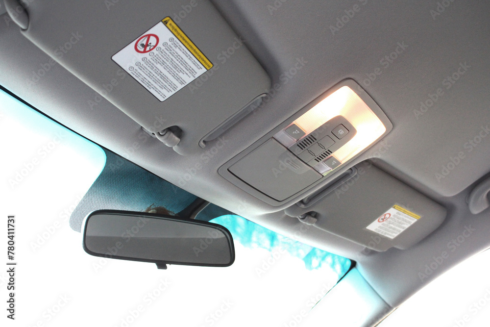 Modern rear view mirror and part of car ceiling. Interior roof car ...