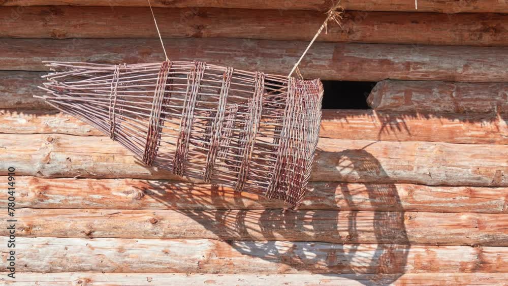 Muzzle is wicker fish trap of top type, made from improvised materials ...