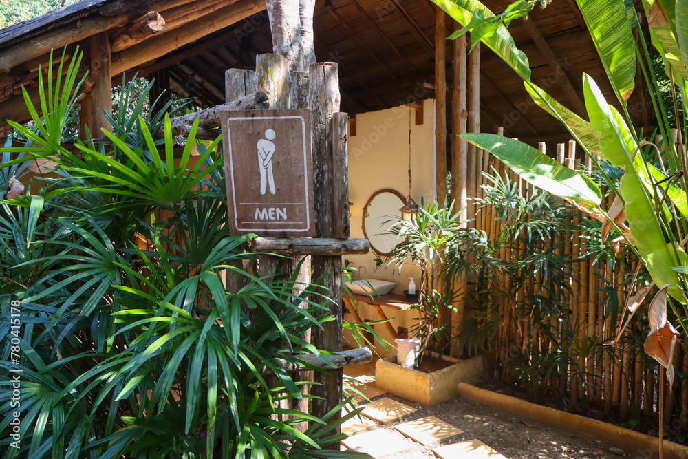 Selective focus: Men's restroom sign decorated with shady trees in ...